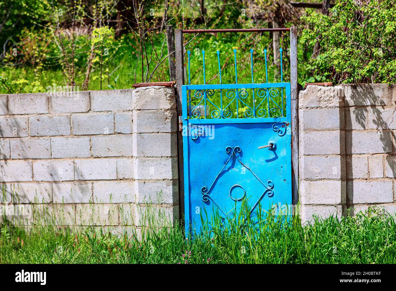 Stone fence and gate . Rustic fence made by bricks Stock Photo - Alamy