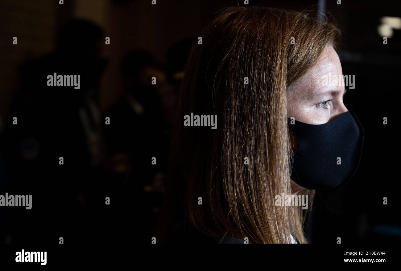 Supreme Court Justice Amy Coney Barrett waits to walk onto the ...