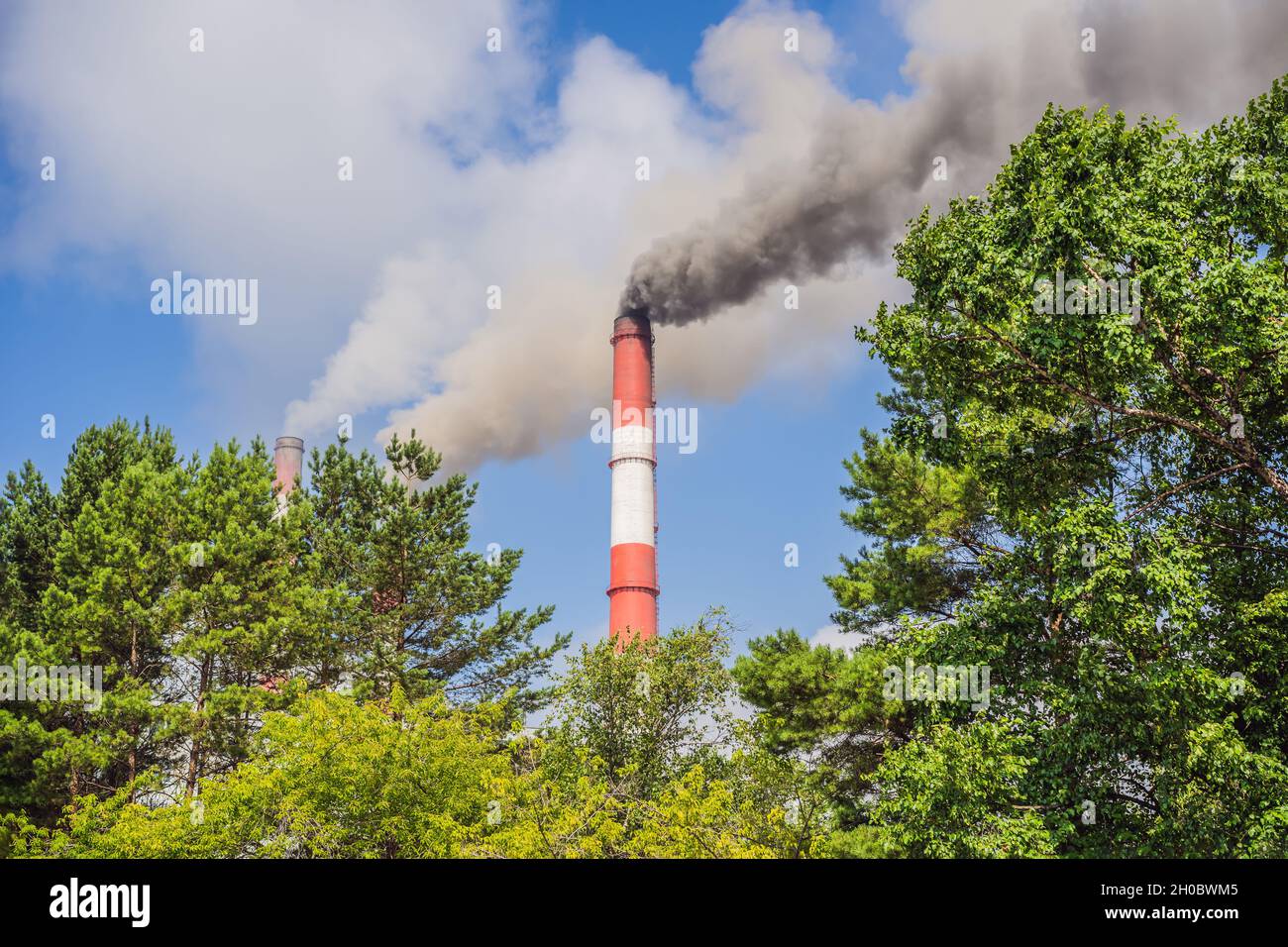 plant pipe with smoke against blue sky Stock Photo - Alamy