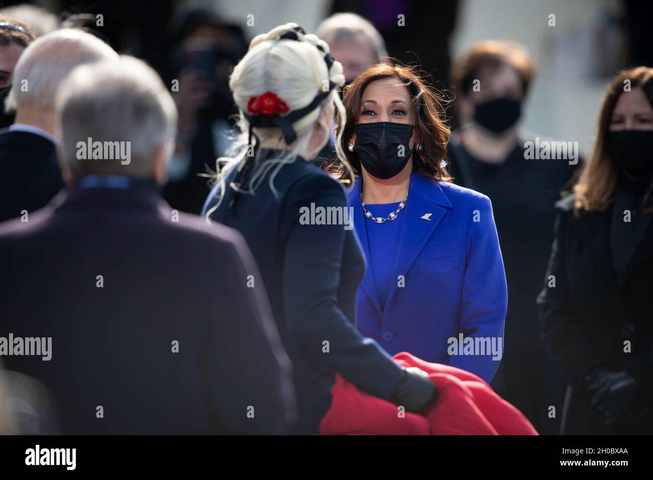 Lady Gaga greets Vice President Kamala Harris before singing a ...