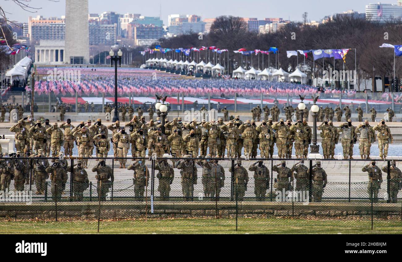 U.S. Soldiers and Airmen with the National Guard salute during the ...