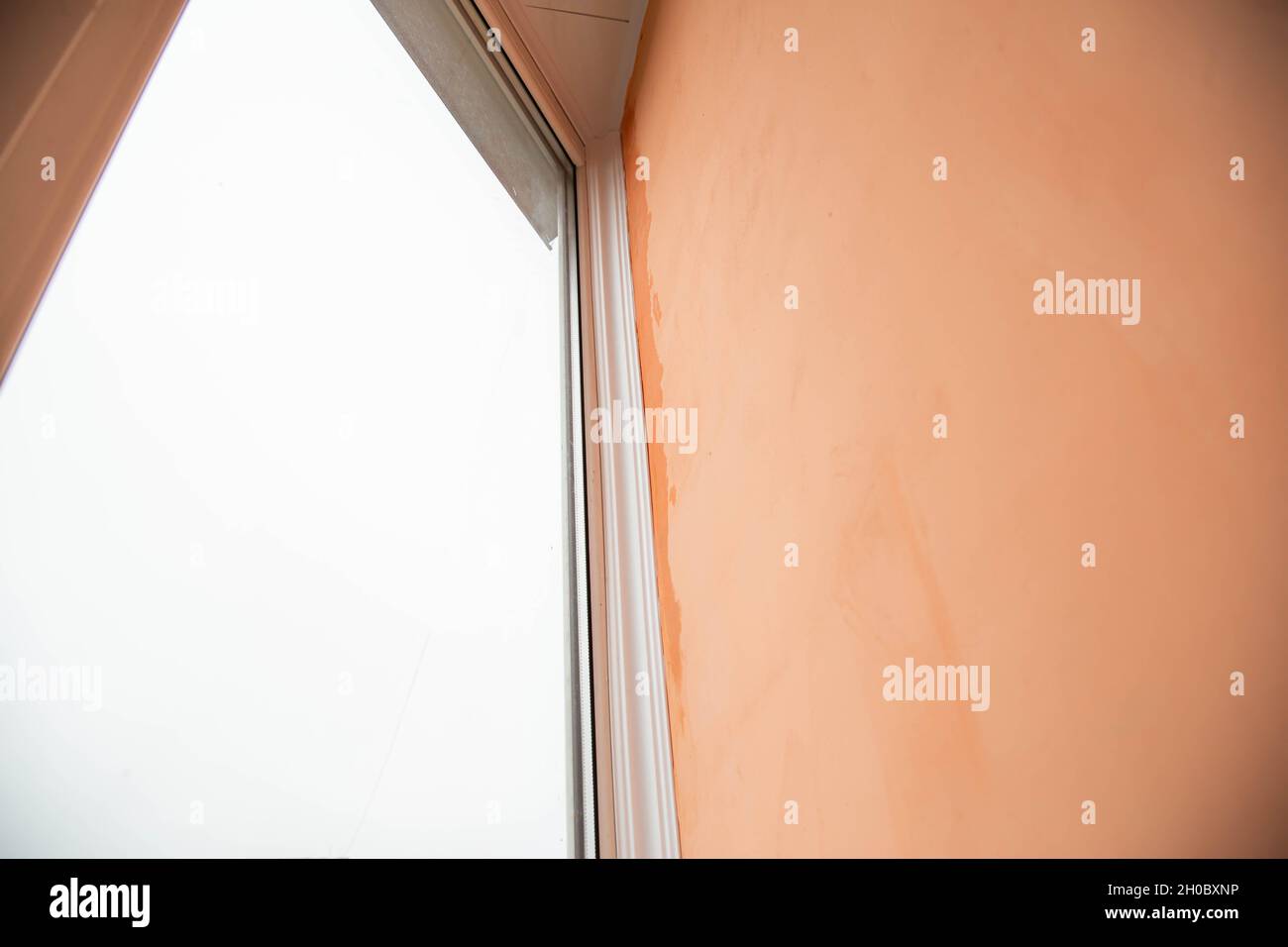 Rain dripping in the corner on the balcony between the window frame and ...