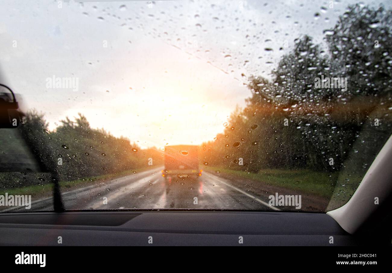 The view from the car through the windshield. Rainy weather, raindrops ...