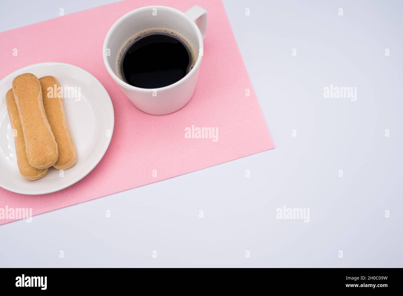 cup of black coffee and light crisp biscuits in a plate Stock Photo - Alamy