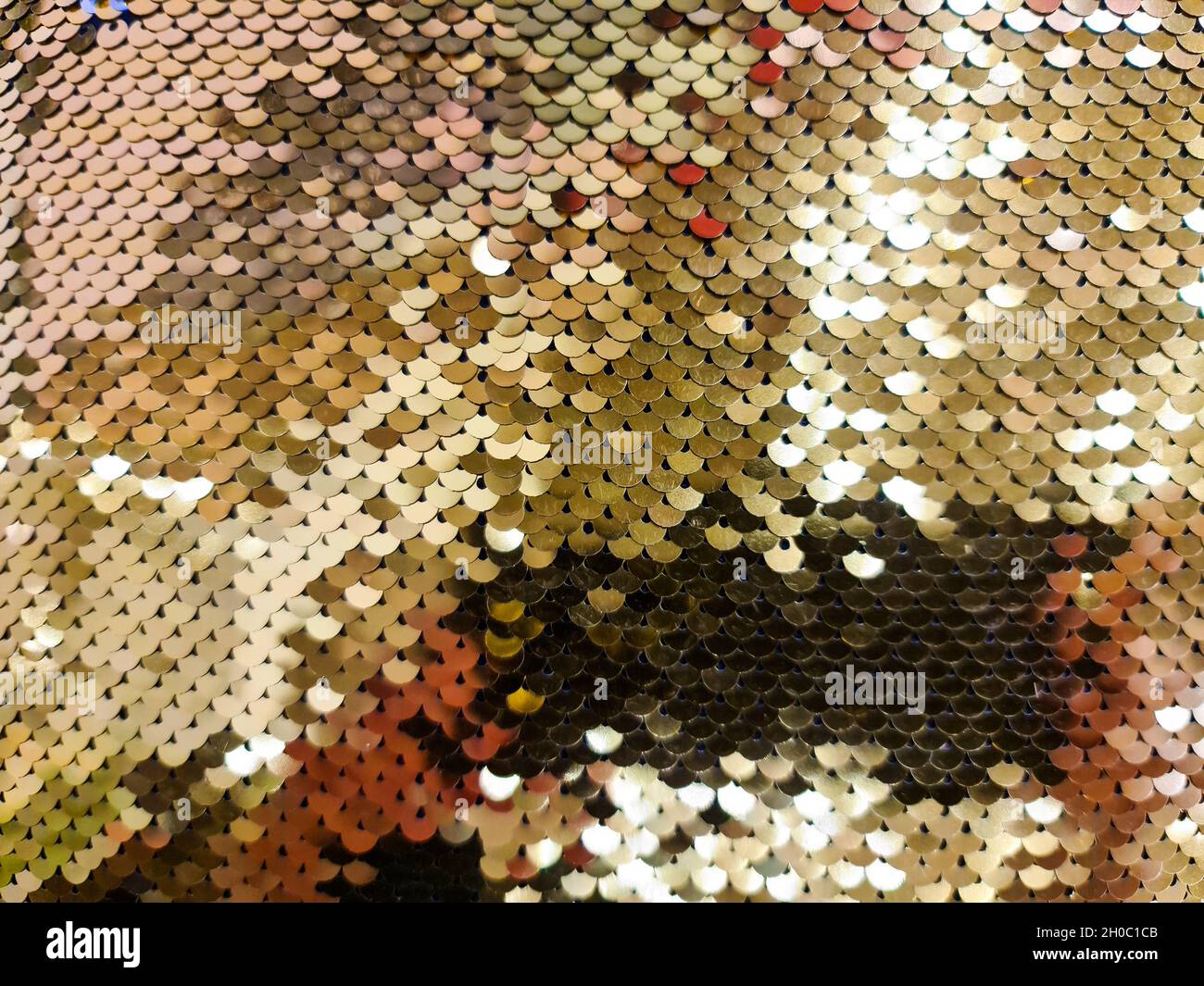 Close up view on samples of sequin fabric in golden colors Stock Photo ...