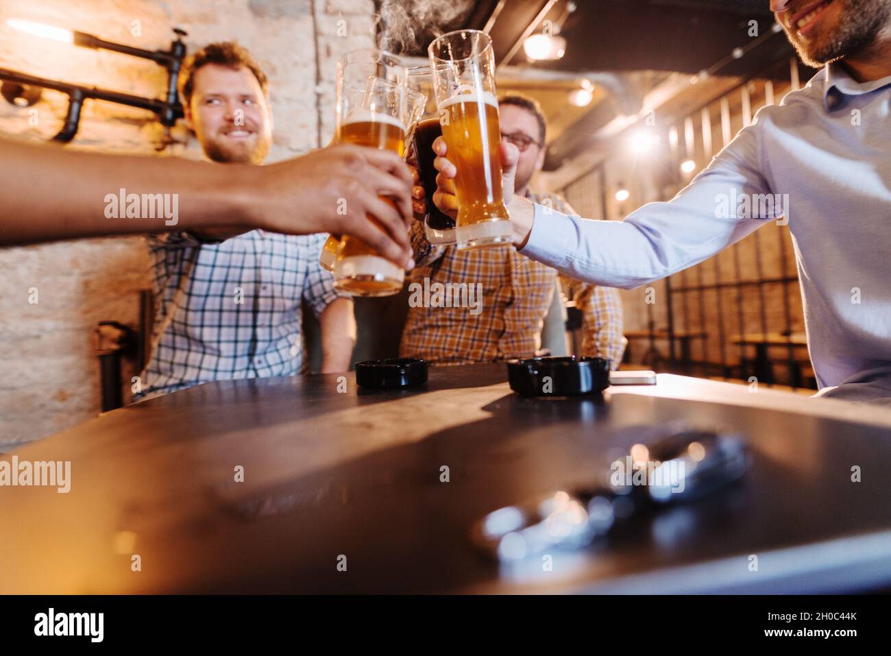 Drunk men drinking beer. On desk car keys. Pub interior Stock Photo - Alamy