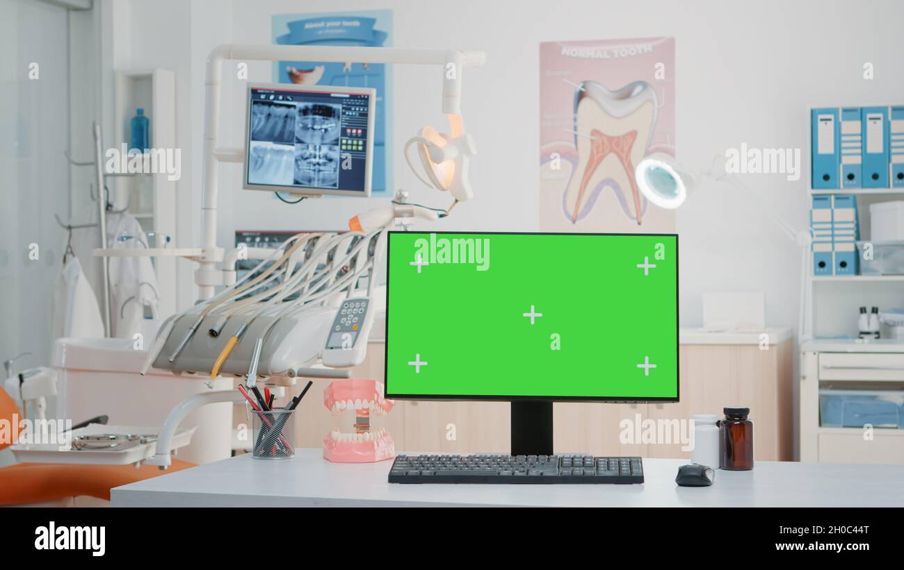 Nobody in dentist office with horizontal green screen on computer and ...