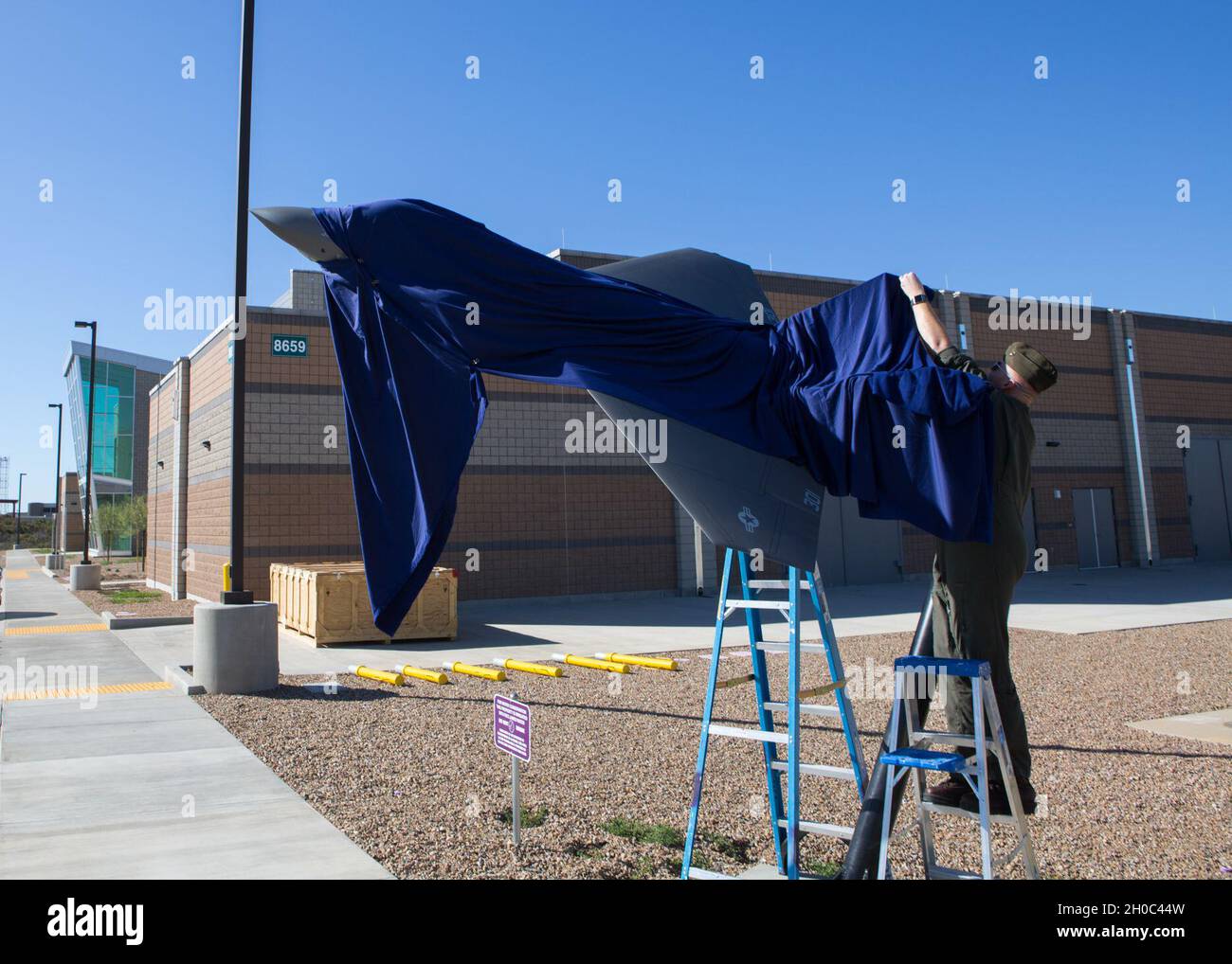 U.S. Marine Corps Major Chad G. Foley prepares a model F-35C Lightning ...