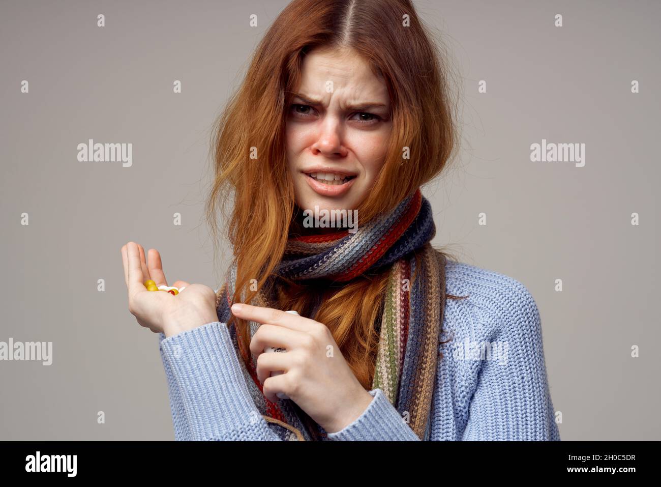 woman cold taking medication light background Stock Photo - Alamy