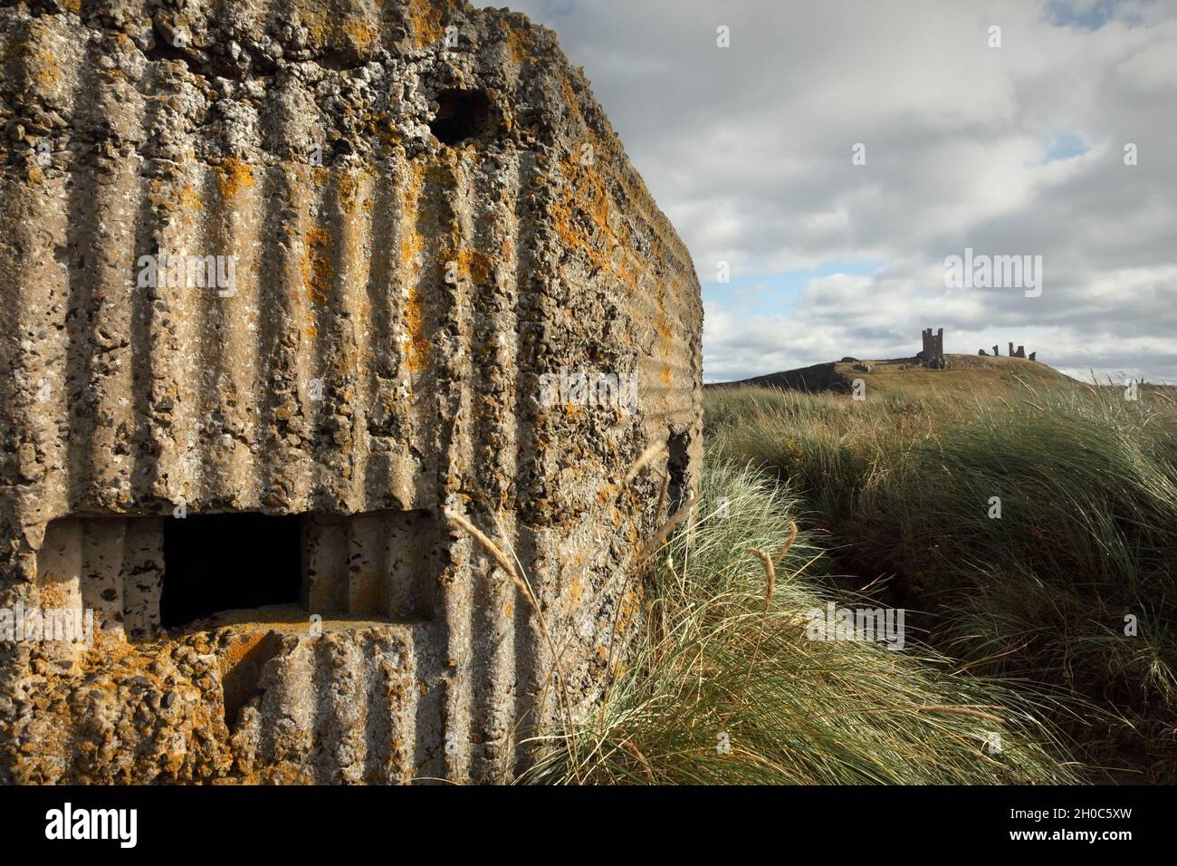 Second World War concrete pillbox near the 14th century Dunstanburgh ...