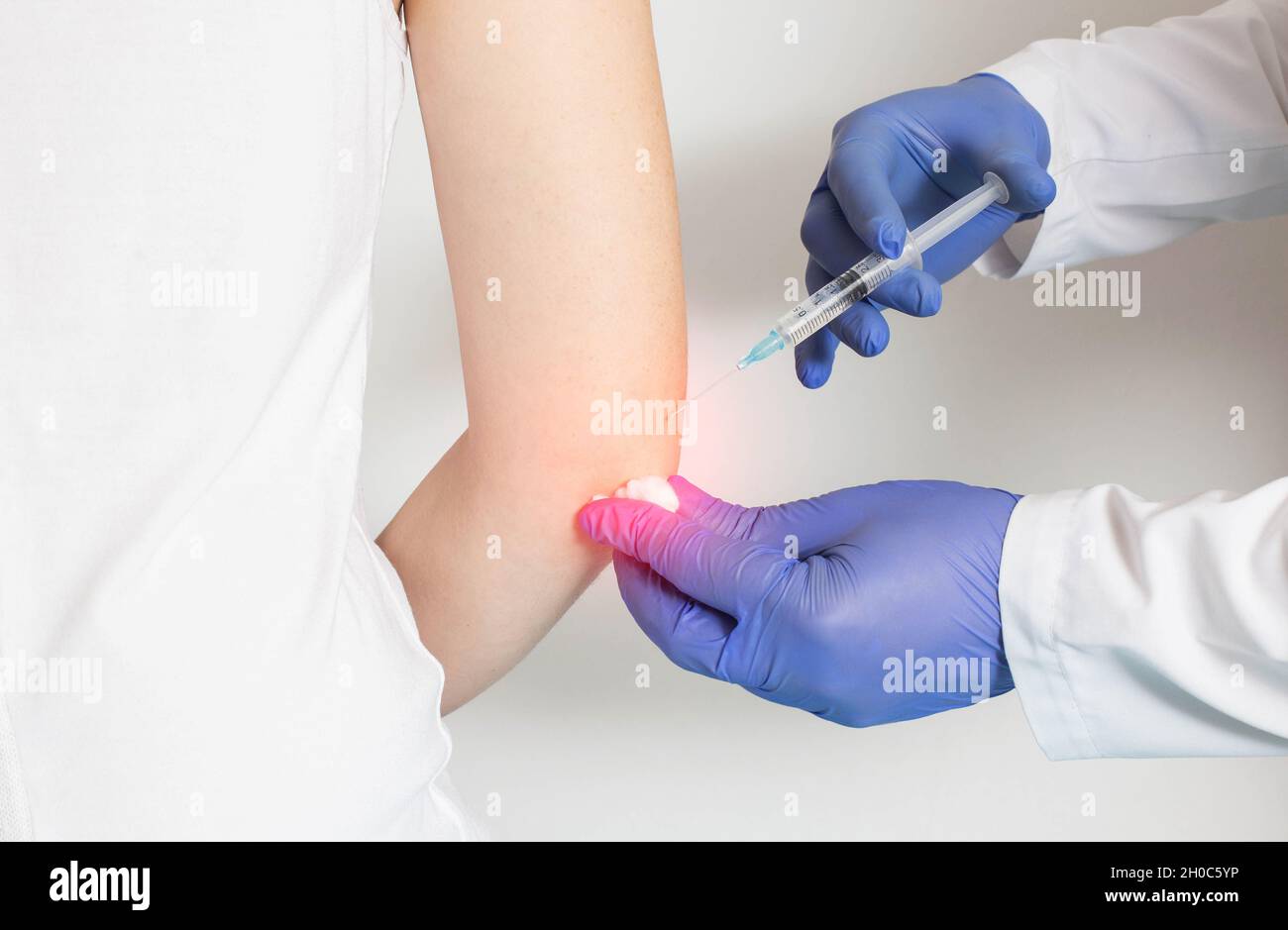 The doctor injects his own platelet-rich plasma into the inflamed elbow ...