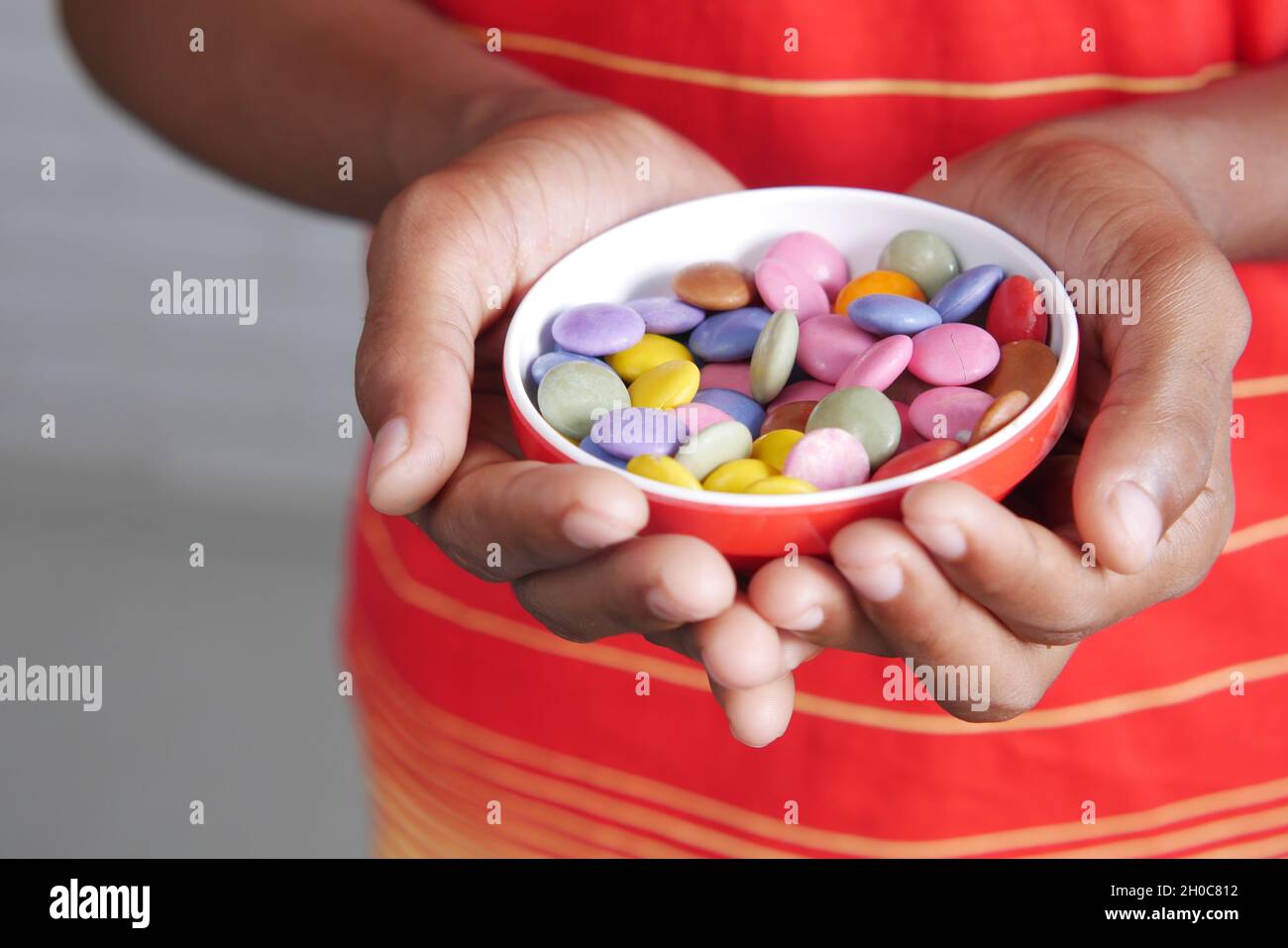 child boy picking multi-colored sweet candies in a bowl close up Stock ...