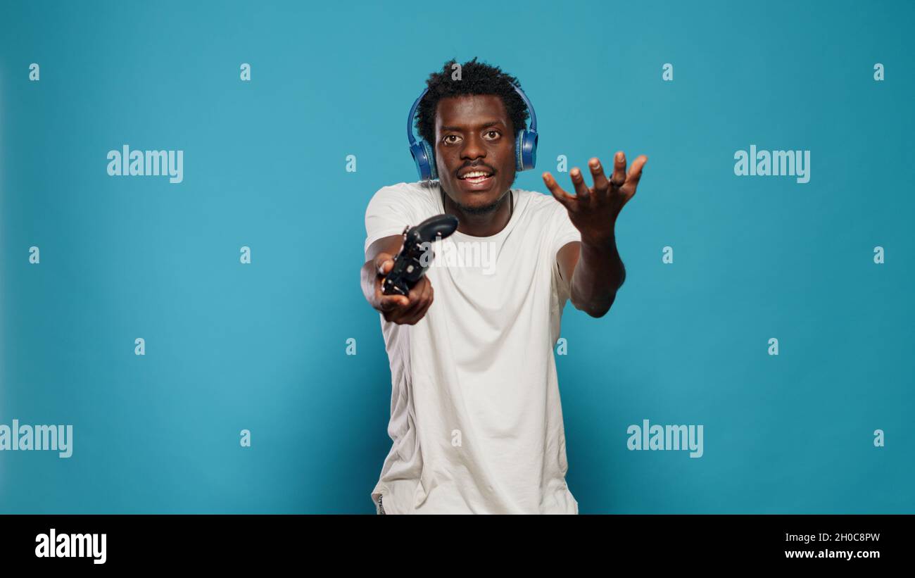 Frustrated man losing at video games on console with controller. Modern ...