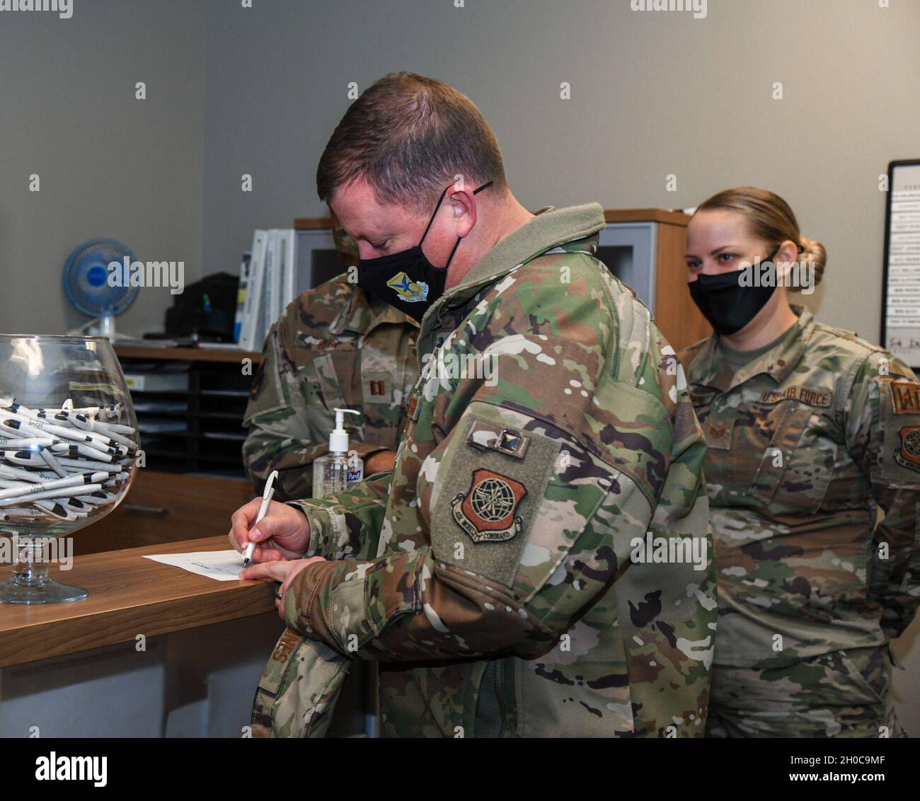 Col. Matthew Jones, 436th Airlift Wing commander, signs a visitor log ...