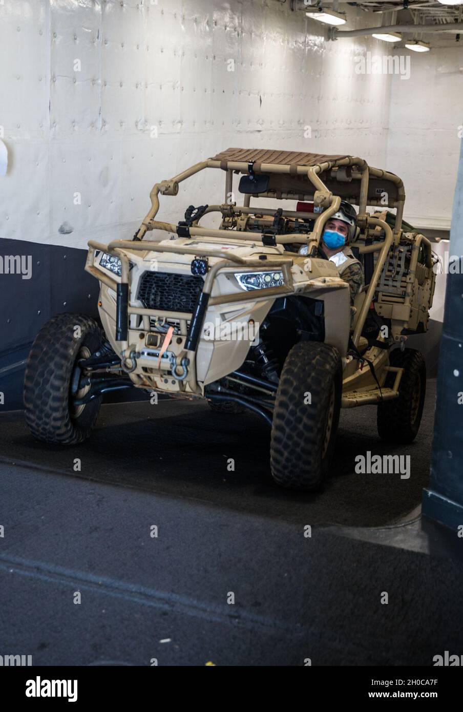 A Marine with the 31st Marine Expeditionary Unit (MEU) drives a light ...
