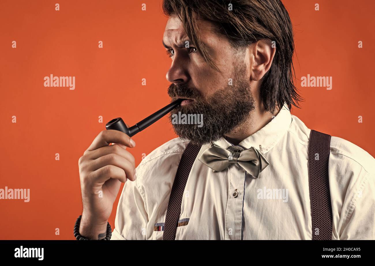 charisma. confident and elegant man in classical wear smoke pipe ...