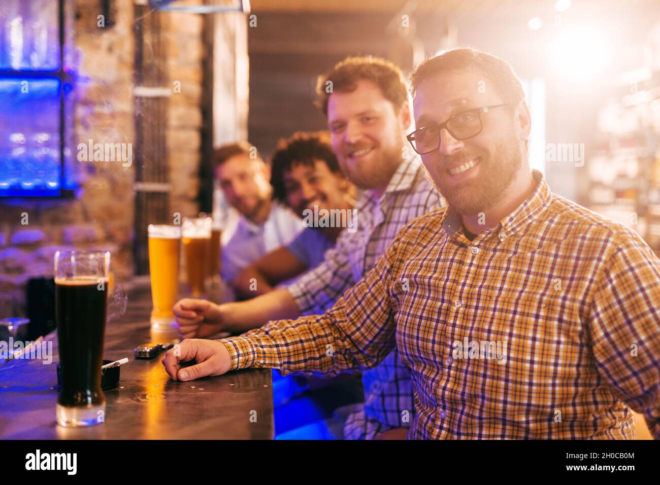 Sitting bar counter friends laughing hi-res stock photography and ...