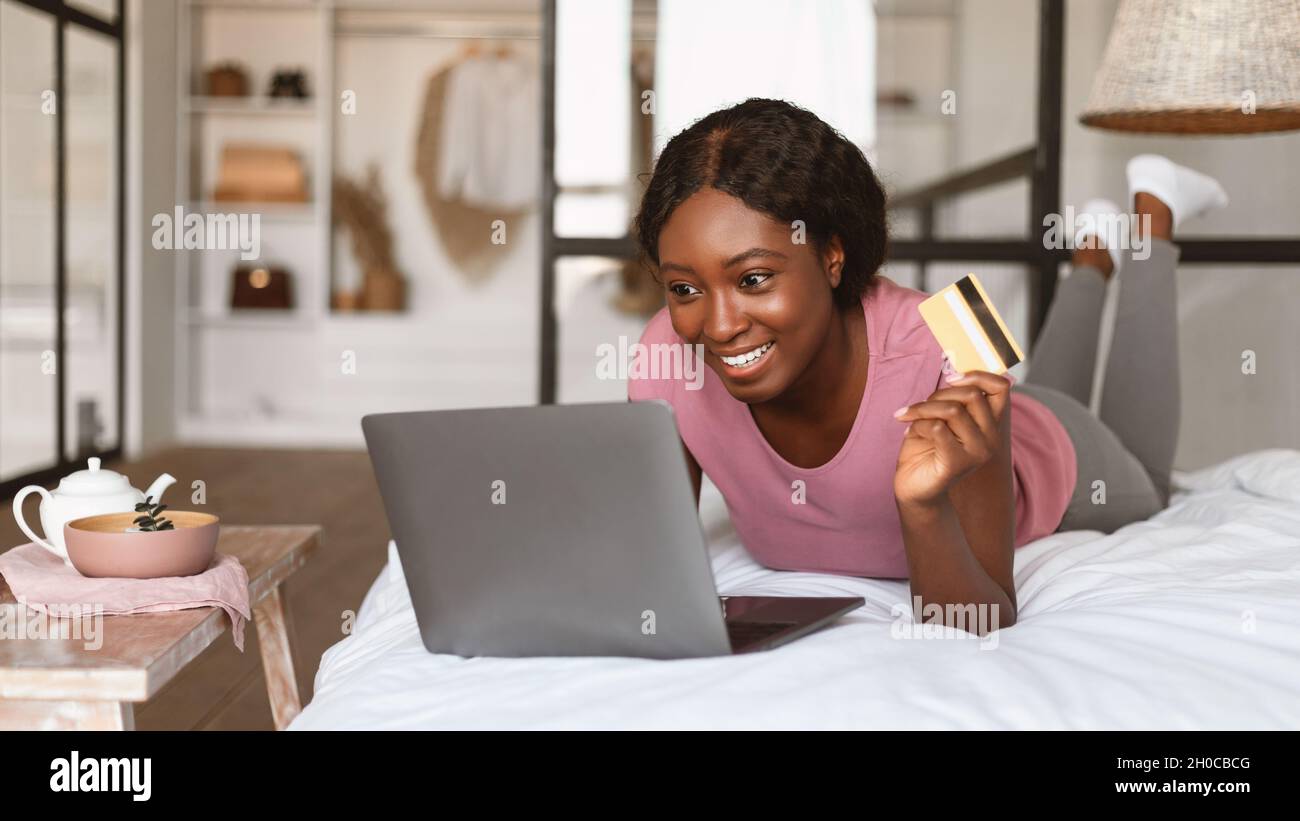 African Lady Using Credit Card And Laptop For Shopping Indoors Stock ...