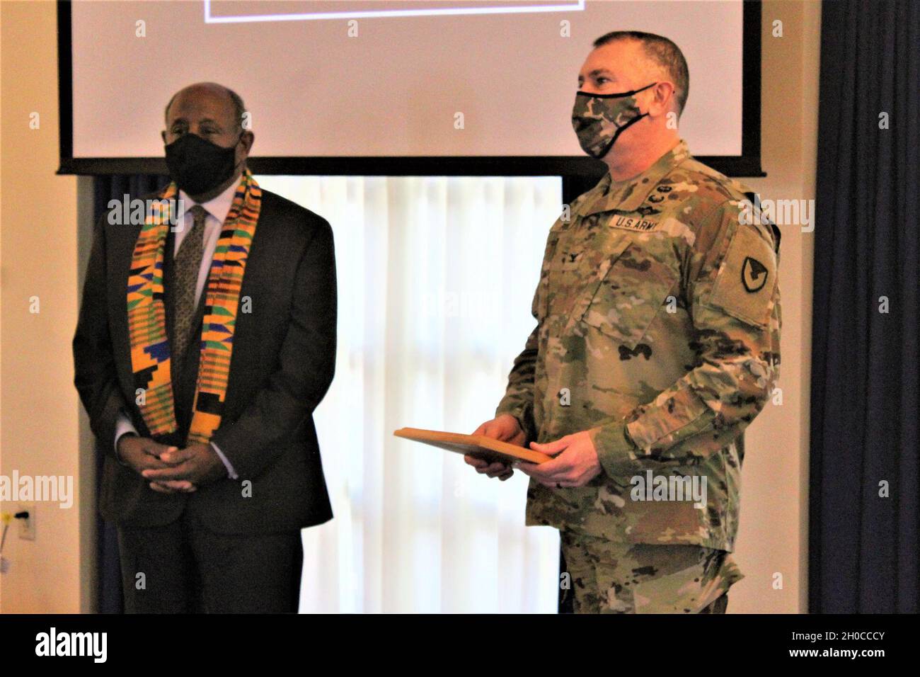 Garrison Commander Col. Michael Poss presents guest speaker Clayborn ...
