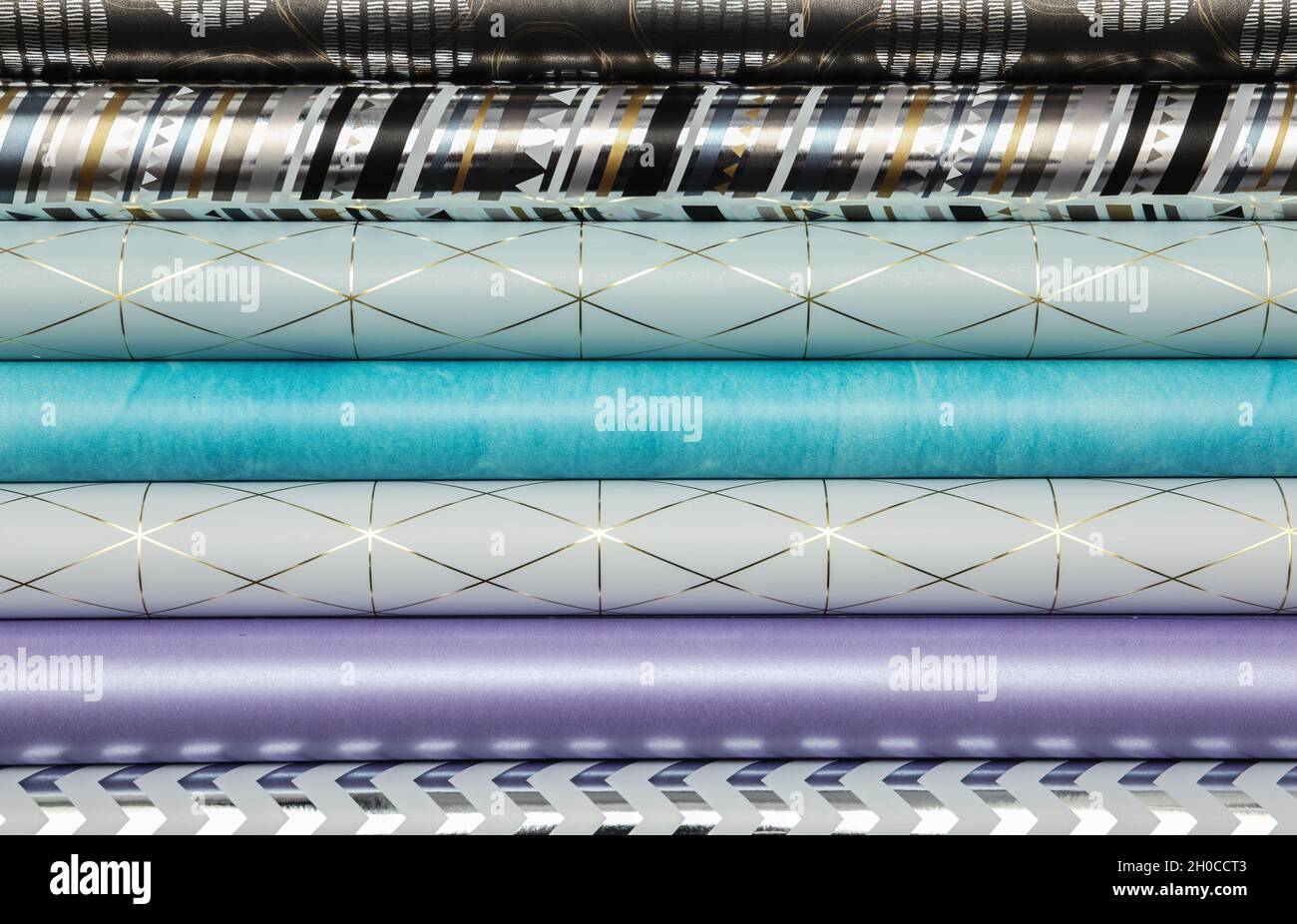 Rolls of festive wrapping paper as background, top view. Gift box ...