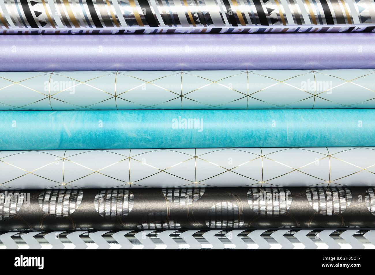 Rolls of festive wrapping paper as background, top view. Gift box ...