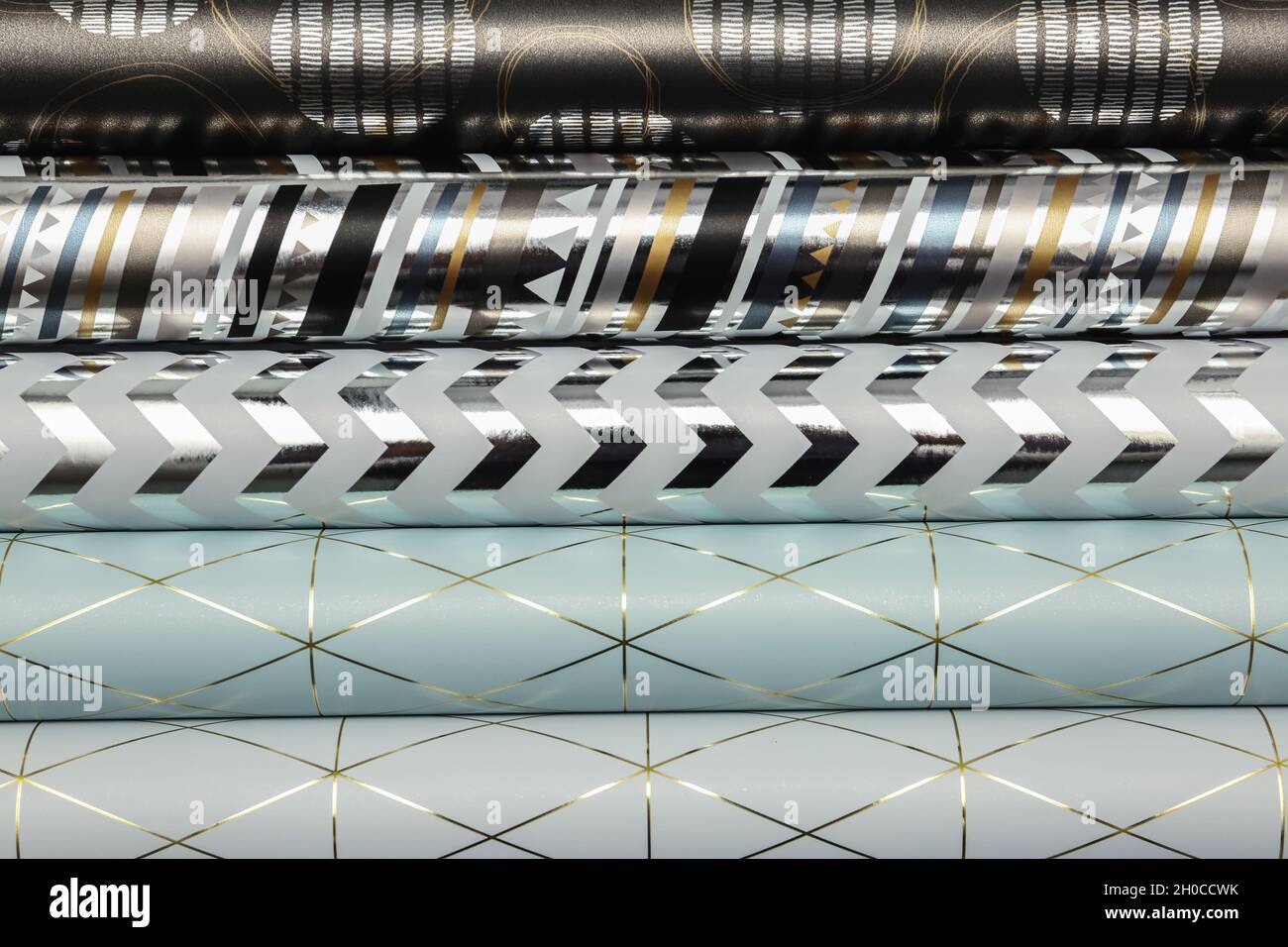 Rolls of festive wrapping paper as background, top view. Gift box ...