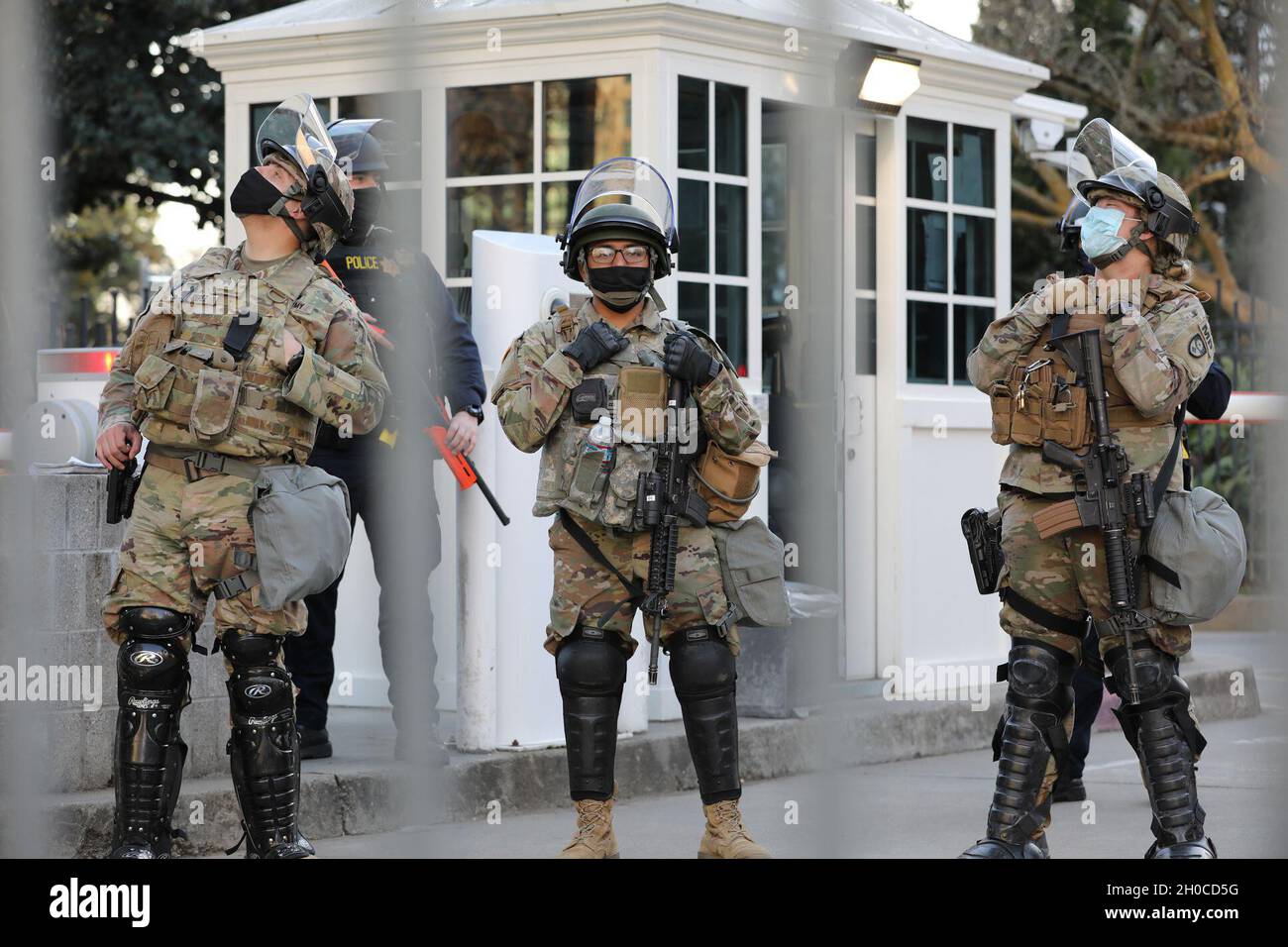 Seen through a metal gate, U.S. Army Sgt. Javier Perez, Spc. Alejandro ...