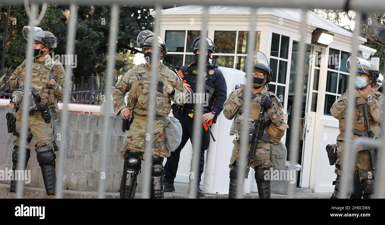 Seen through a metal gate, U.S. Army Spc. Beckett Calvert, Sgt. Javier ...