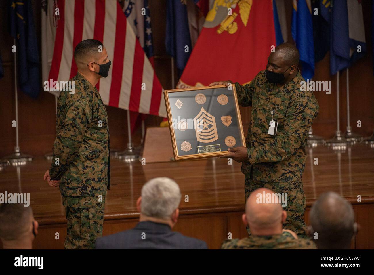 Sgt. Maj. Carlos Ruiz, outgoing sergeant major of 4th Marine Logistics Group, is presented with ...