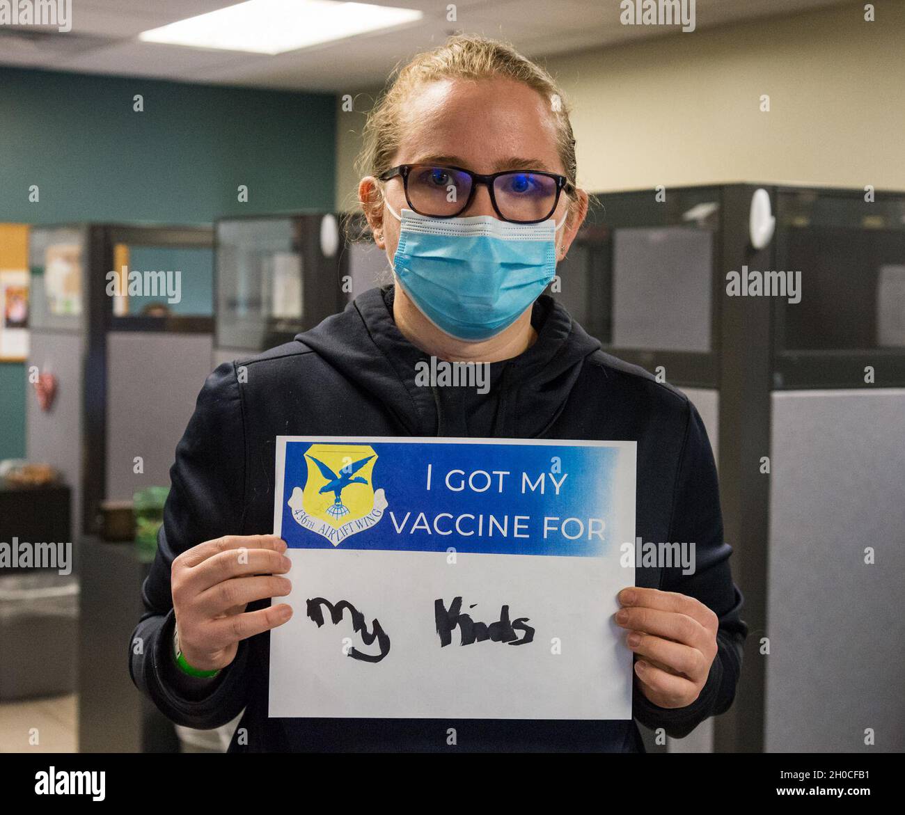 Sarah Carter, Defense Commissary Agency worker, displays a sign stating ...