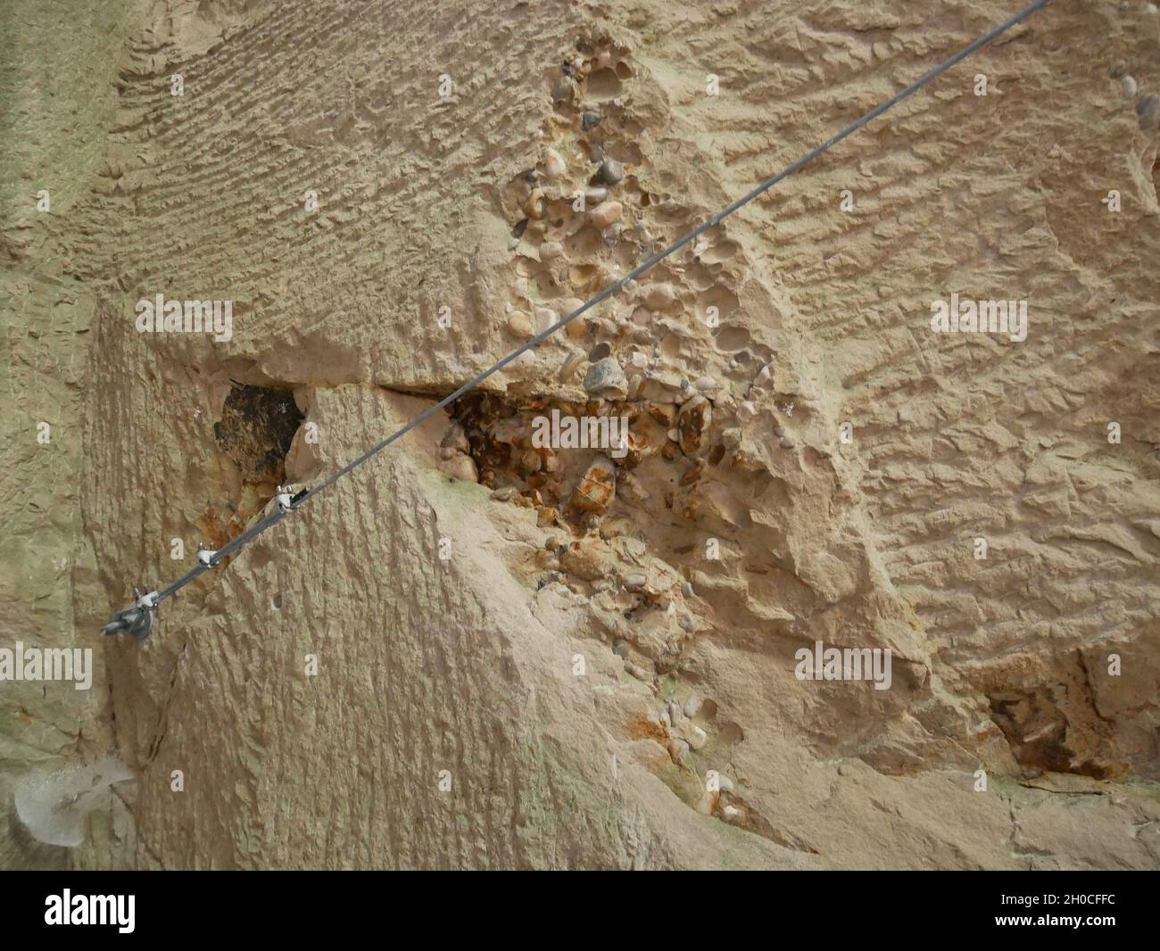 Closeup of a cable attached to a cliff Stock Photo - Alamy