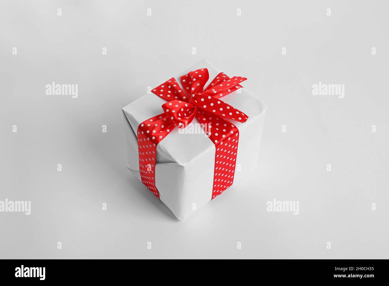 Beautifully wrapped gift box on white background Stock Photo - Alamy