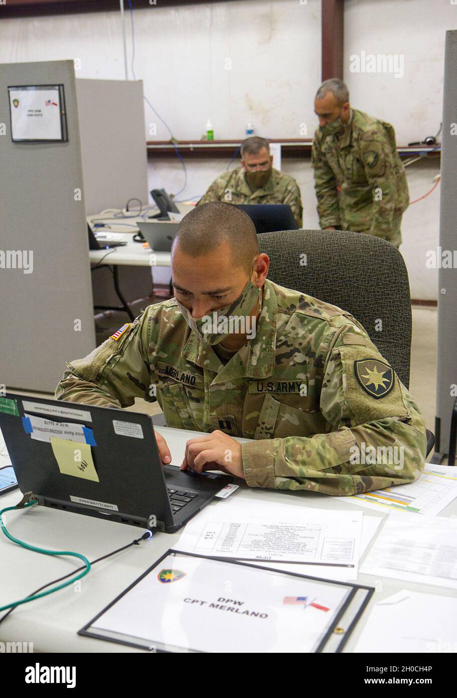 Army Capt. Alejandro Merlano (foreground), director of public works ...