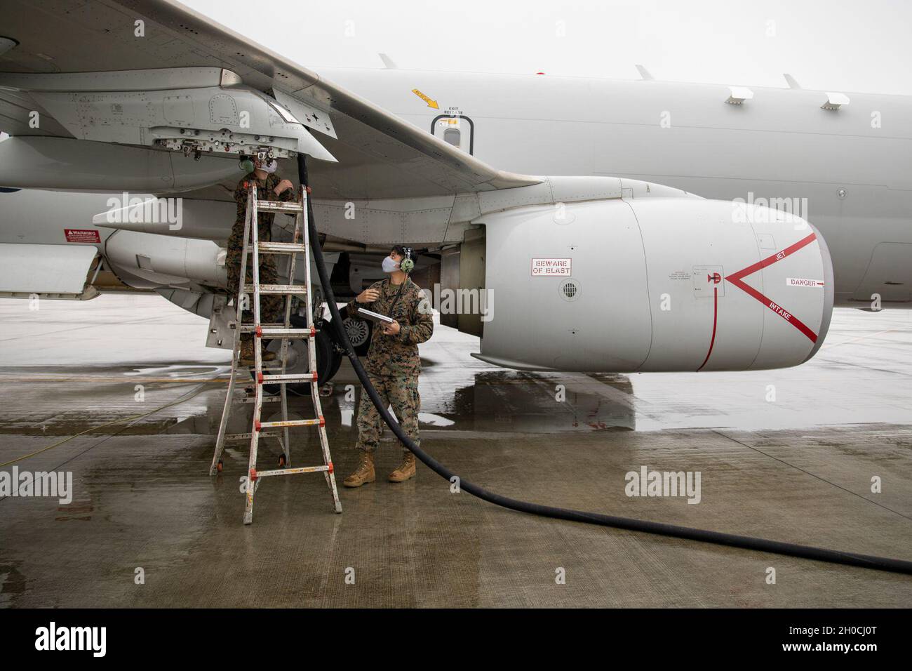 U.S. Marines with Marine Wing Support Squadron (MWSS) 171 refuel a U.S ...