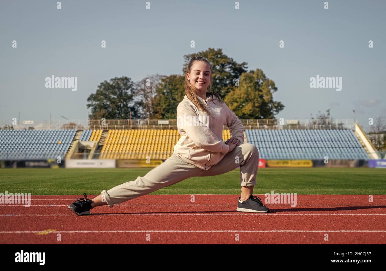 runner prepare for race competition. sprinter warming up on stadium gym ...