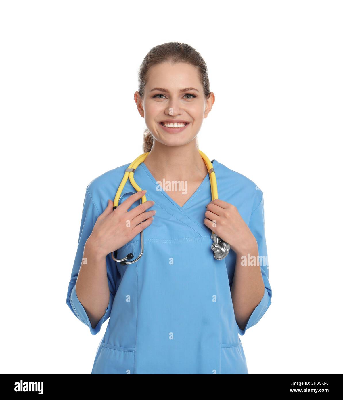 Portrait of young medical assistant with stethoscope on white ...