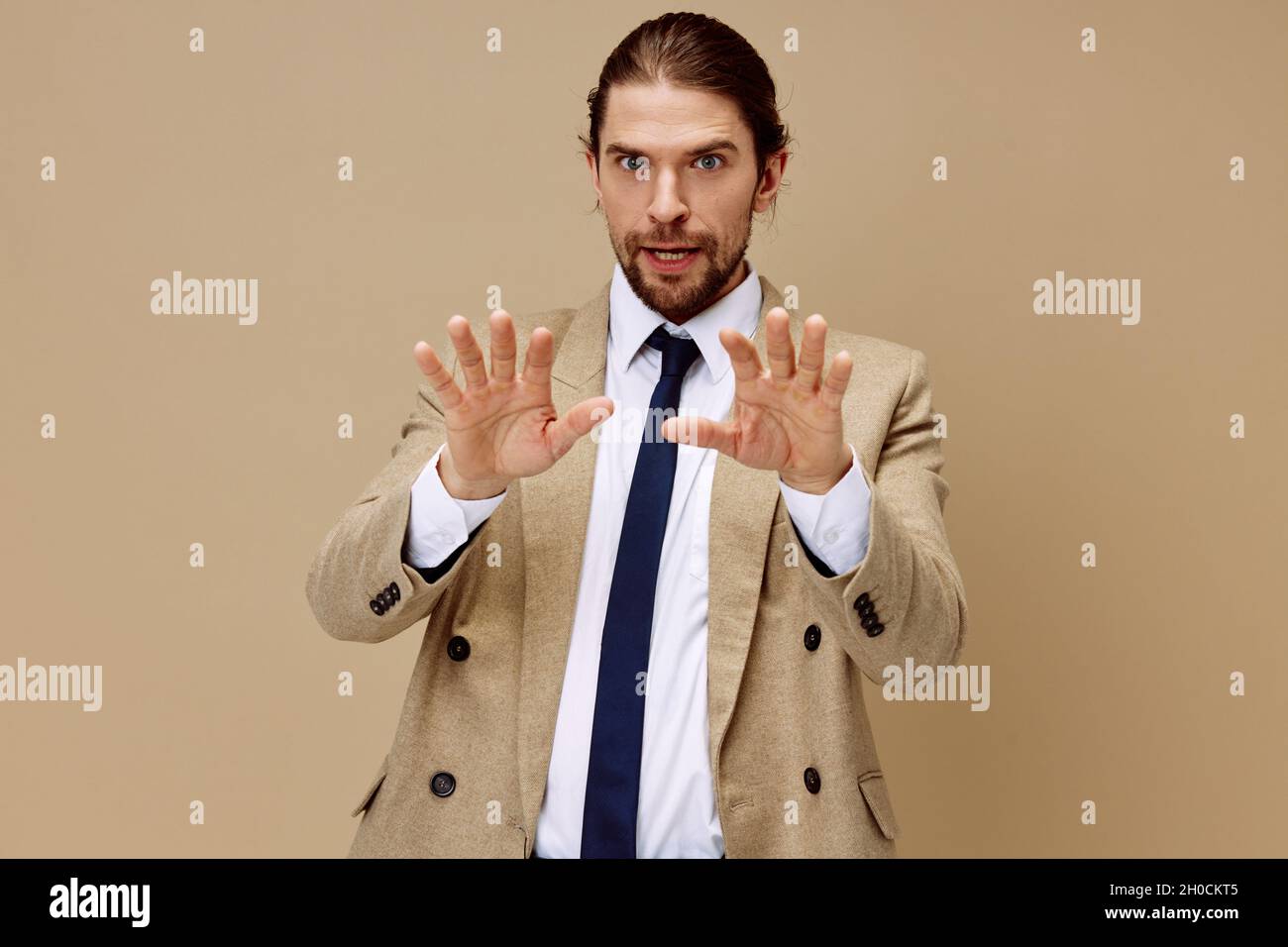 Man in beige suit standing hi-res stock photography and images - Alamy