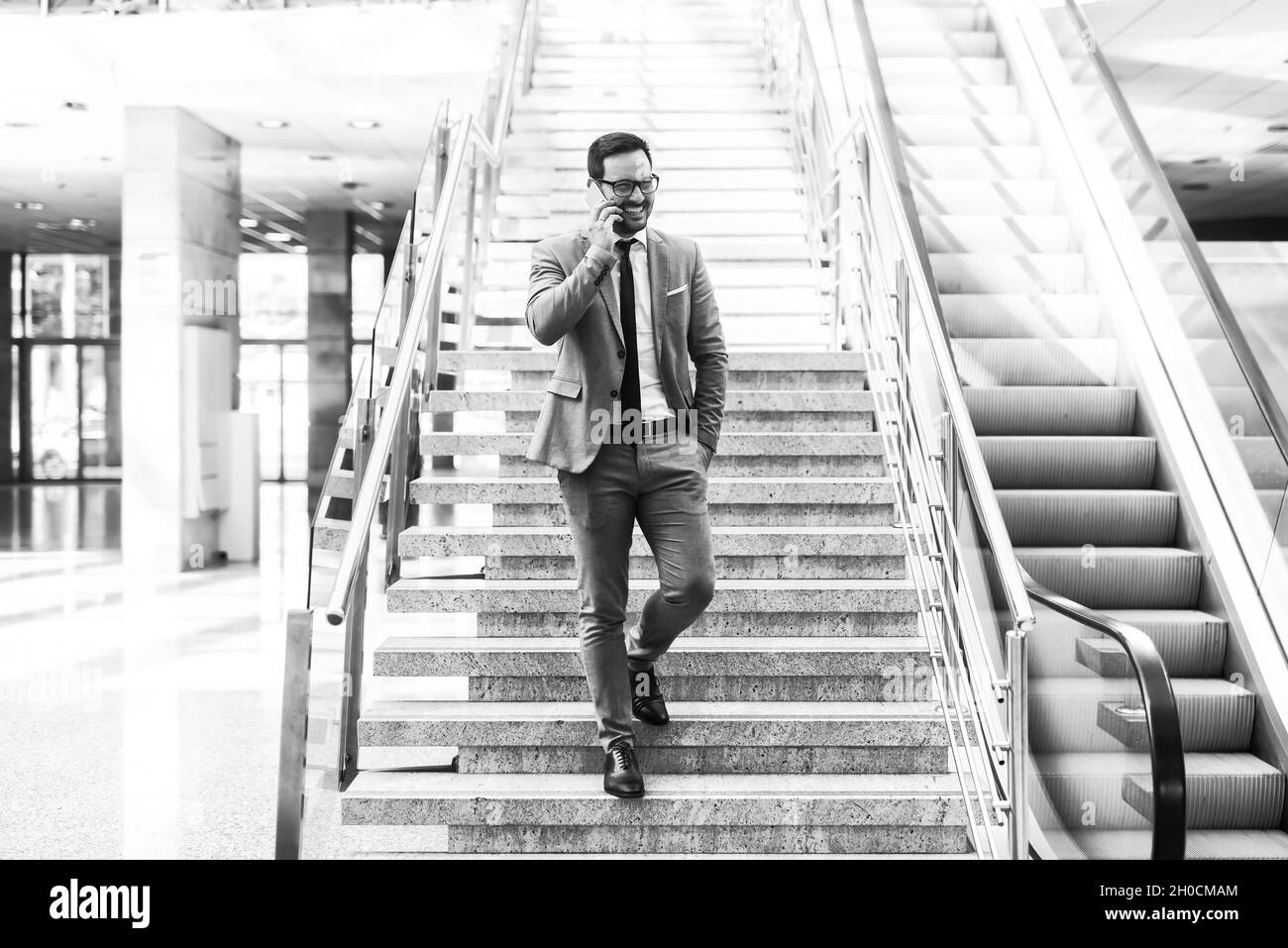Smart man walking down steps hi-res stock photography and images - Alamy