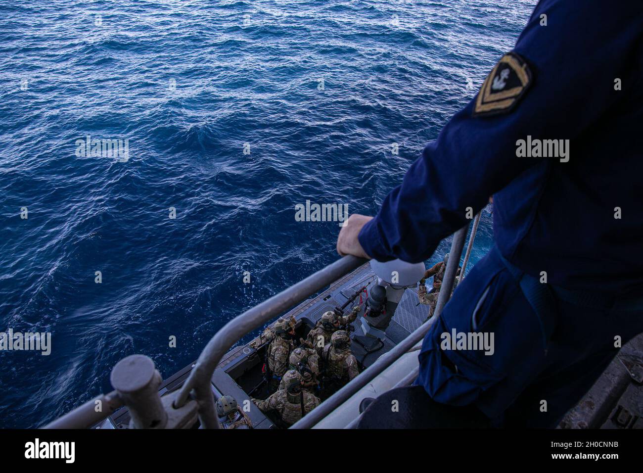 A Hellenic Navy crew member aboard the HS Kanaris communicates with a ...