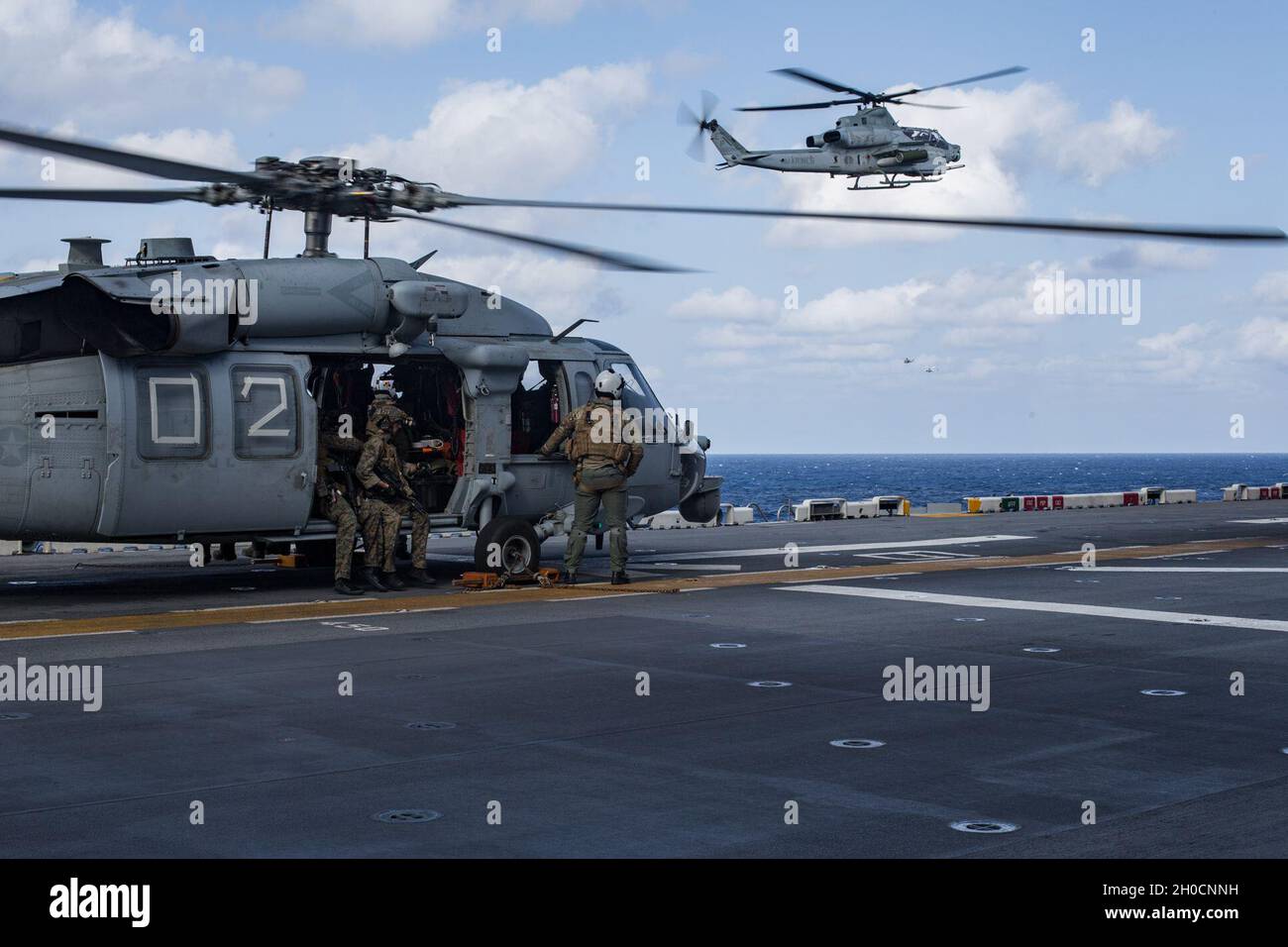 U.S. Marines with 31st Marine Expeditionary Unit (MEU) load onto a MH ...