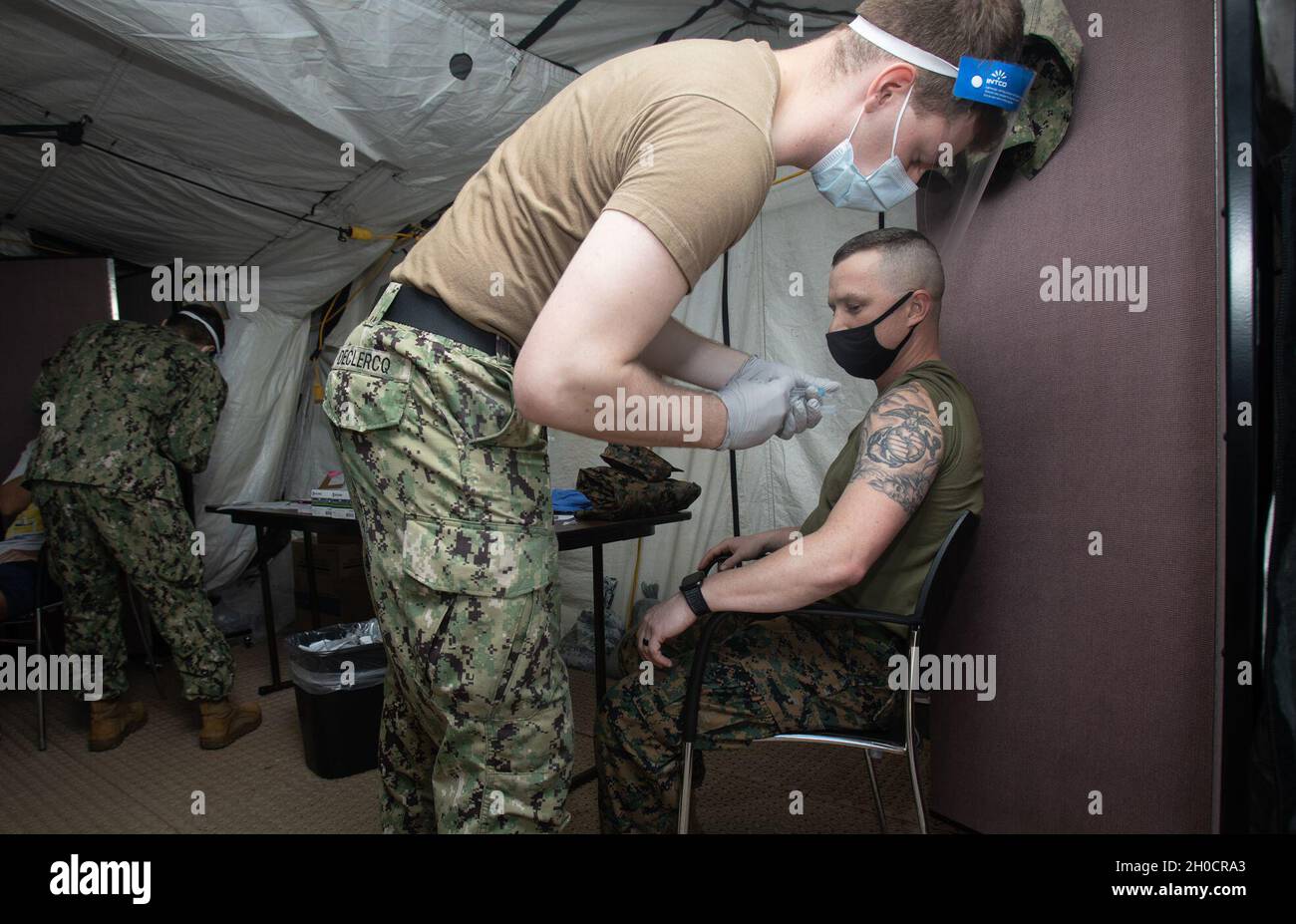 U.S. Marine Corps Capt. Eric Mees, right, supply officer with Marine ...