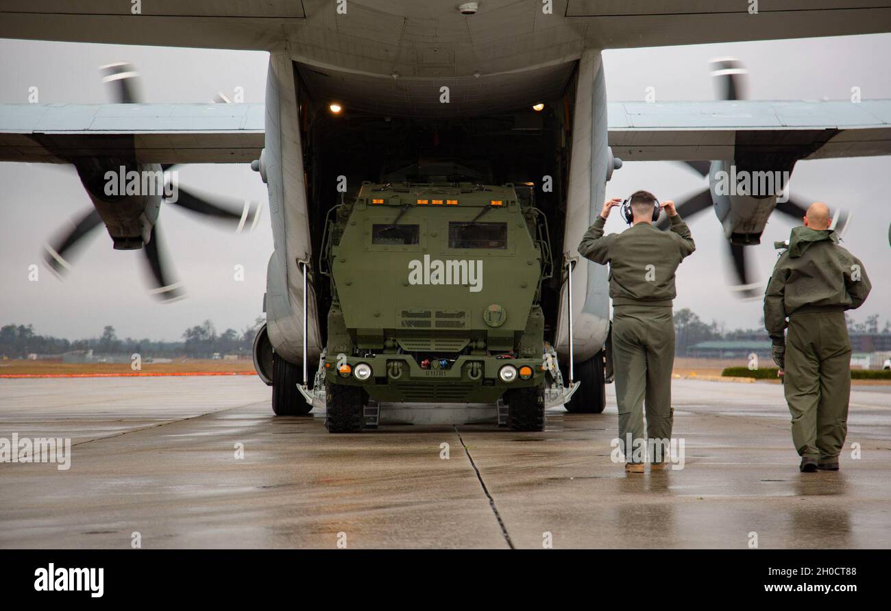 U.S. Marines guide a M142 High Mobility Artillery Rocket Systems from a ...