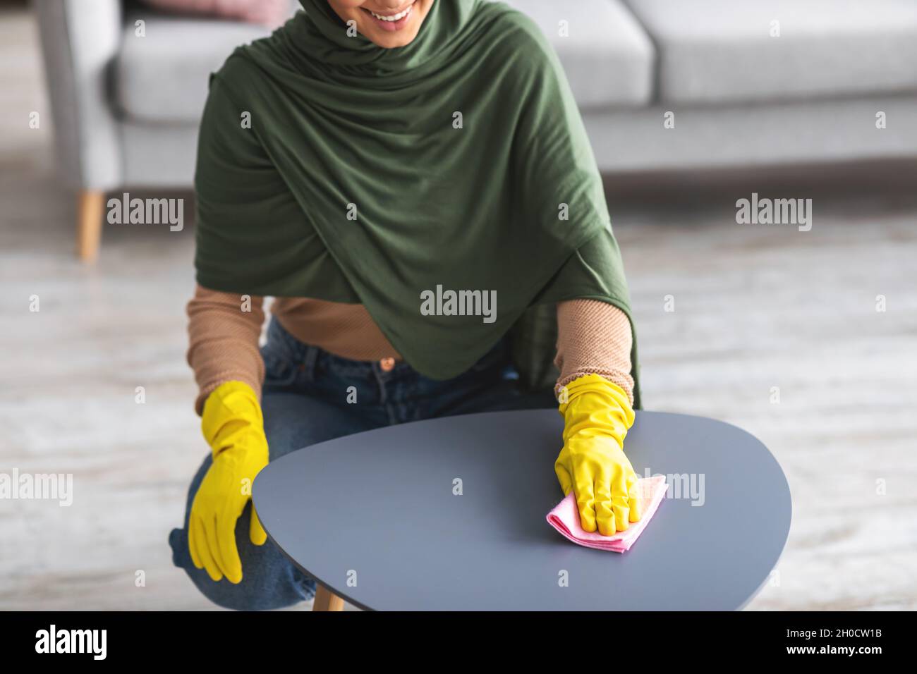 Closeup of young muslim woman cleaning table with cloth Stock Photo - Alamy