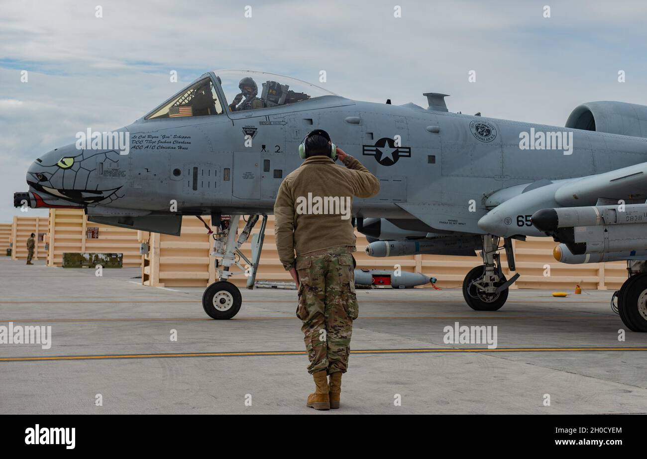 U.S. Air Force Senior Airman Joshua Baer salutes Lt. Col. Ryan “Gus ...