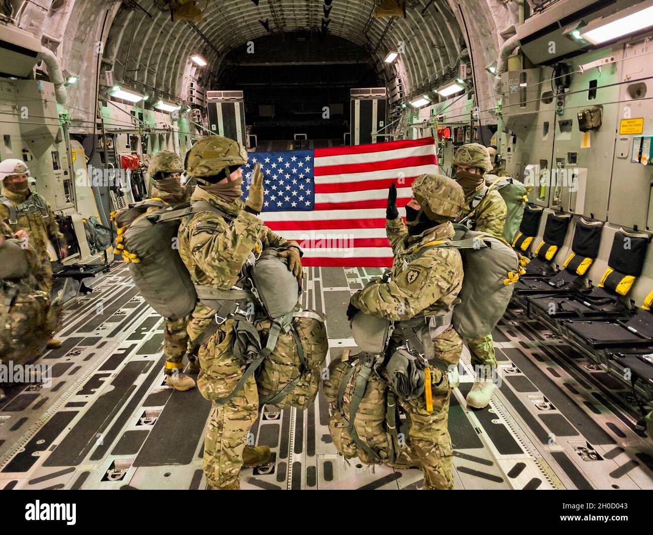 Maj. Travis Young administers the oath of enlistment to Staff Sgt ...