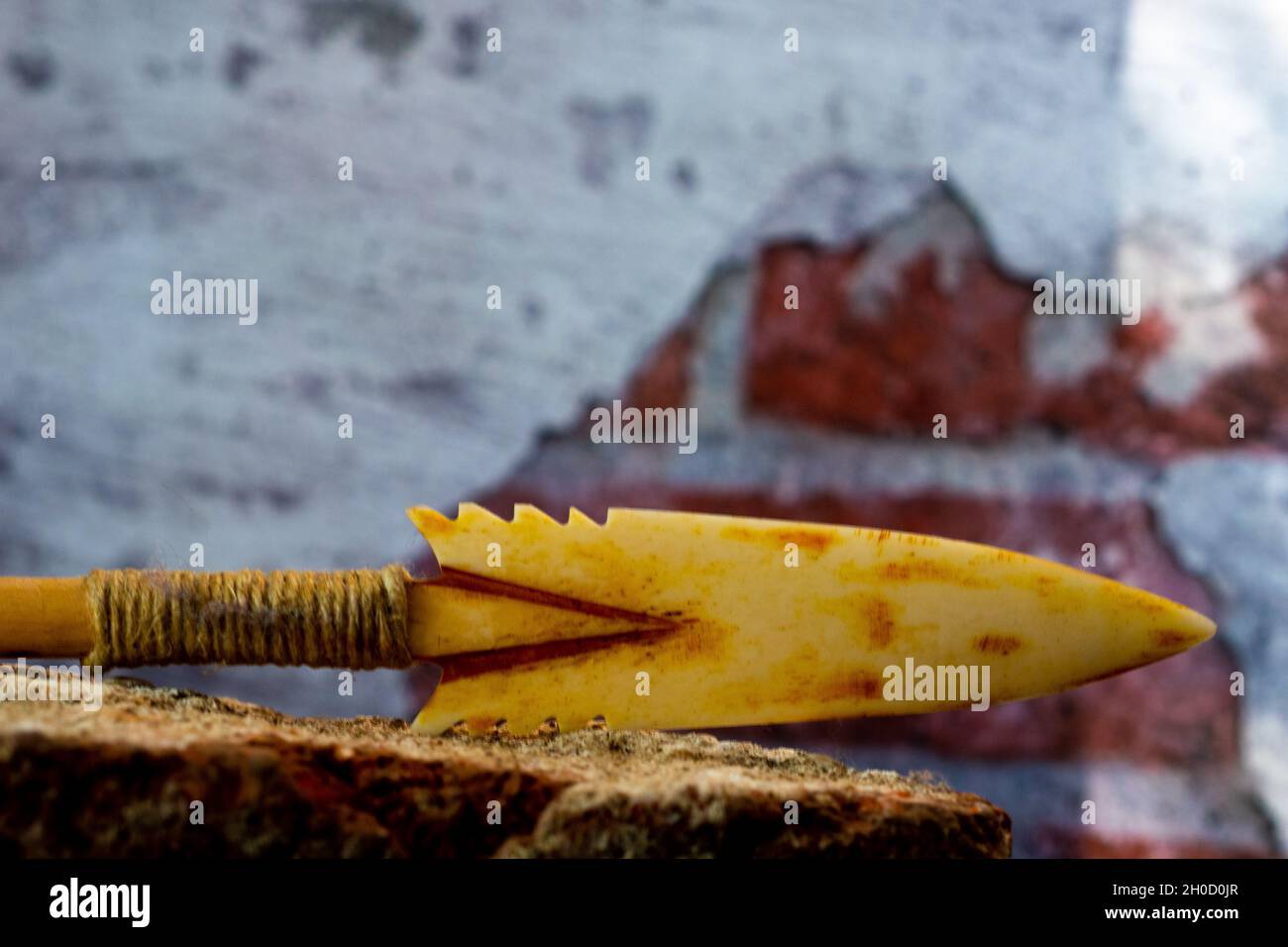 bone arrowhead with brick wall Stock Photo - Alamy