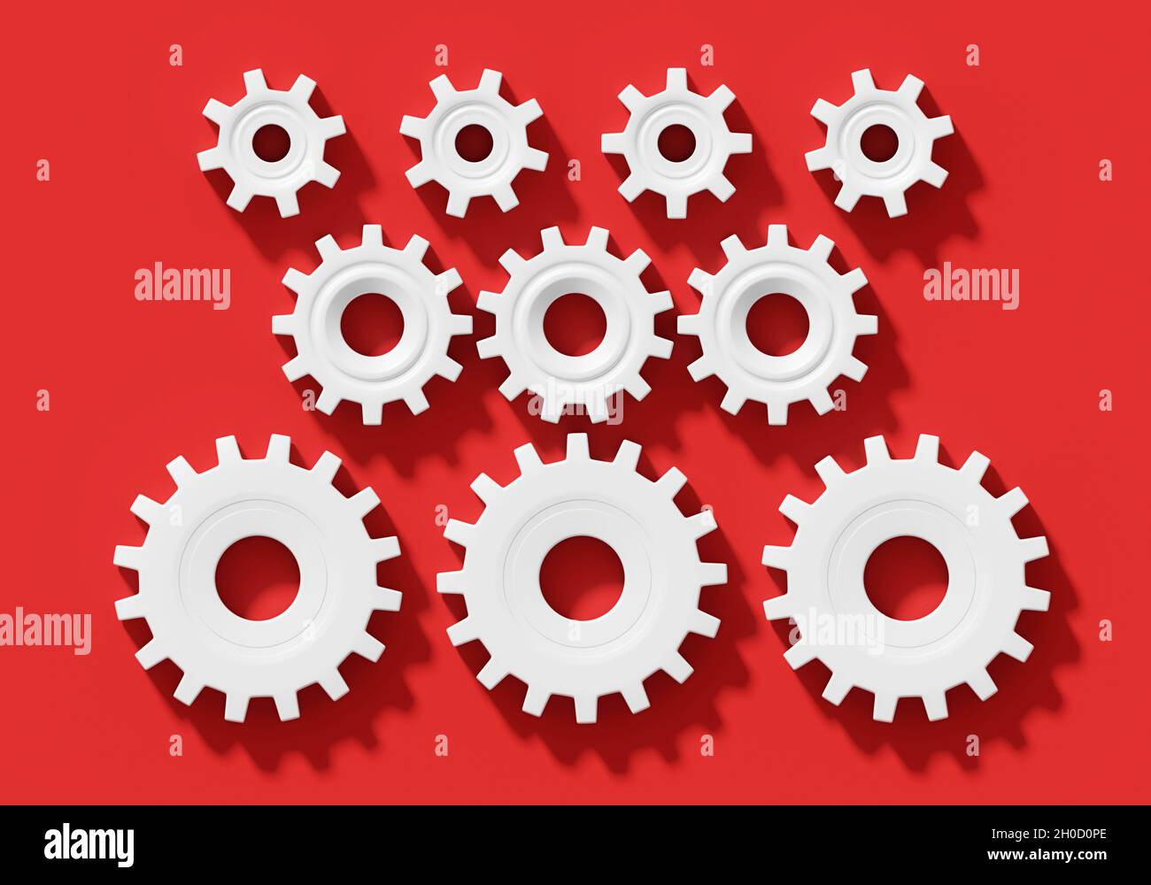 Many white gear cogs of different sizes arranged in three rows isolated ...