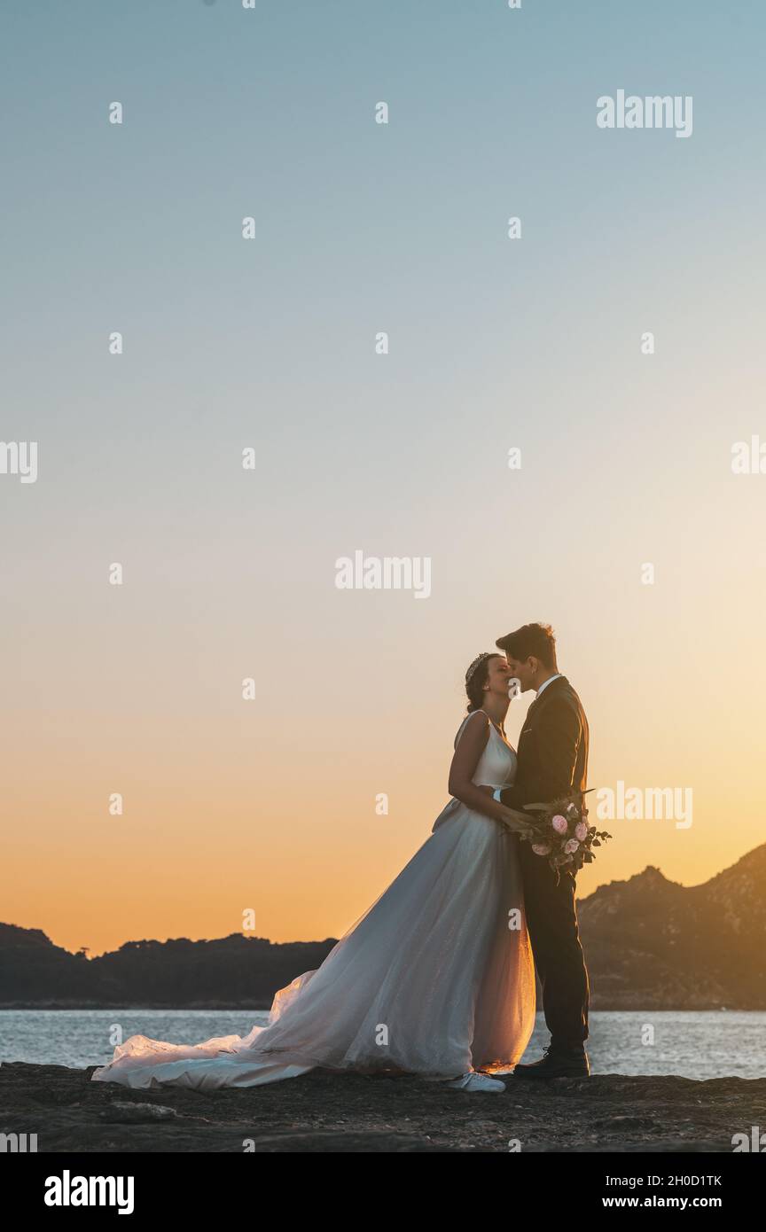 Just married couple against the sky with copy space Stock Photo - Alamy