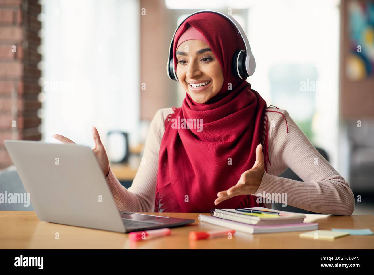 Happy muslim woman having video conference with colleagues Stock Photo ...
