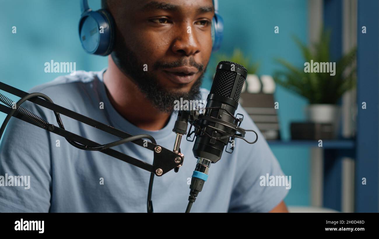 Close up of vlogger using microphone for conversation with subscribers ...